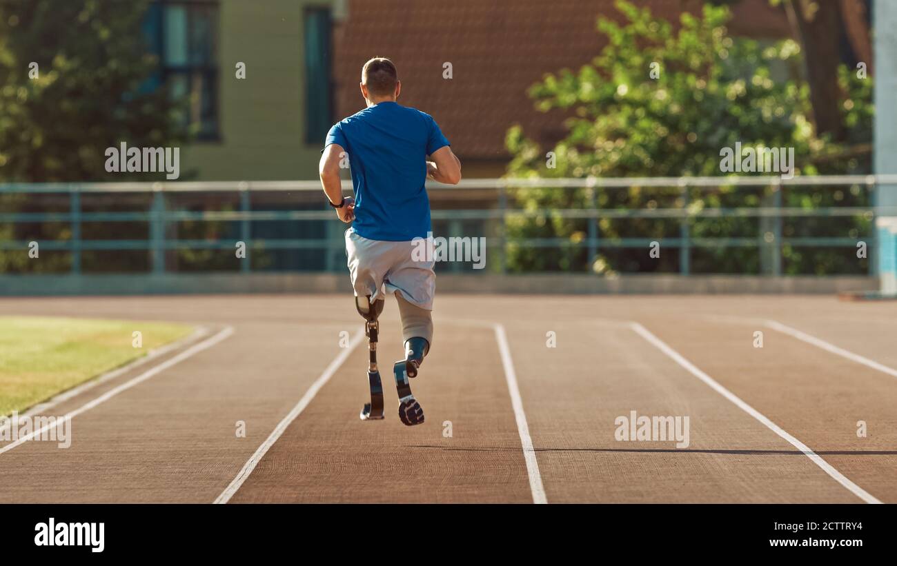 Athletic Disabled Fit Man with Prosthetic Running Blades is Training on ...