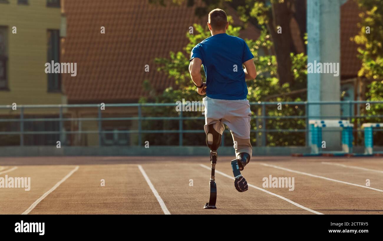 Athletic Disabled Fit Man with Prosthetic Running Blades is Training on ...