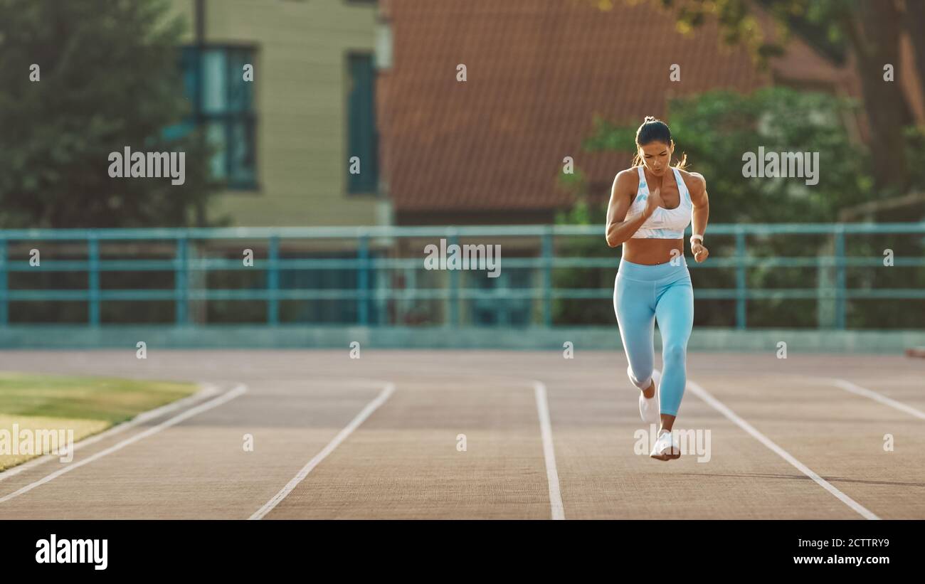 Beautiful Fitness Woman in Light Blue Athletic Top and Leggings is ...
