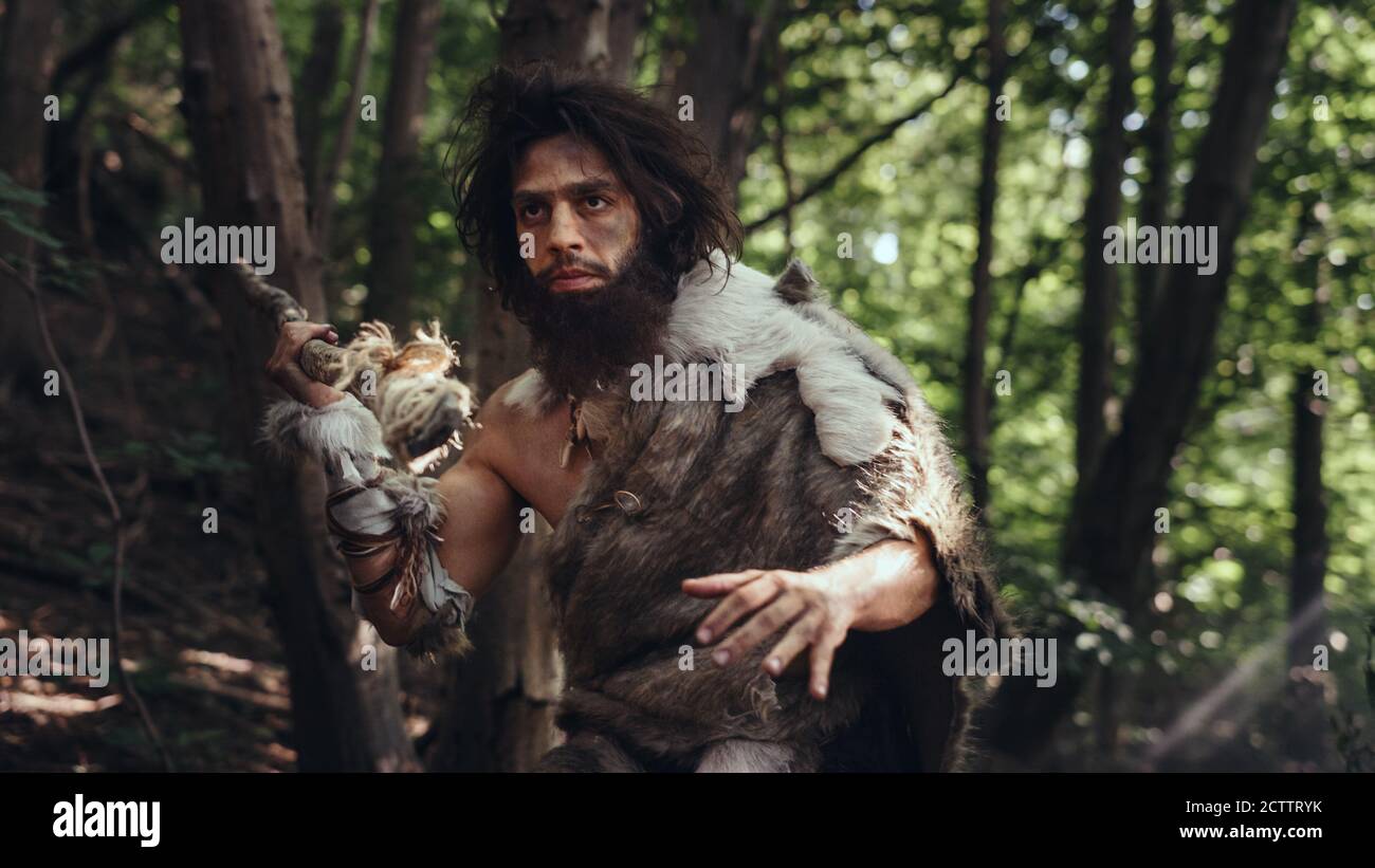 Portrait of Primeval Caveman Wearing Animal Skin and Fur Hunting with a ...