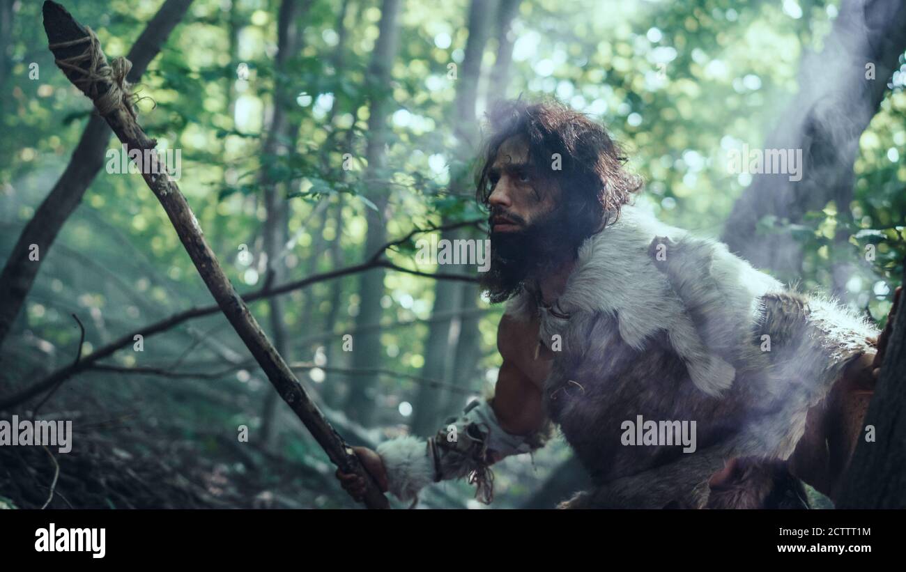 Portrait of Primeval Caveman Wearing Animal Skin and Fur Hunting with a ...