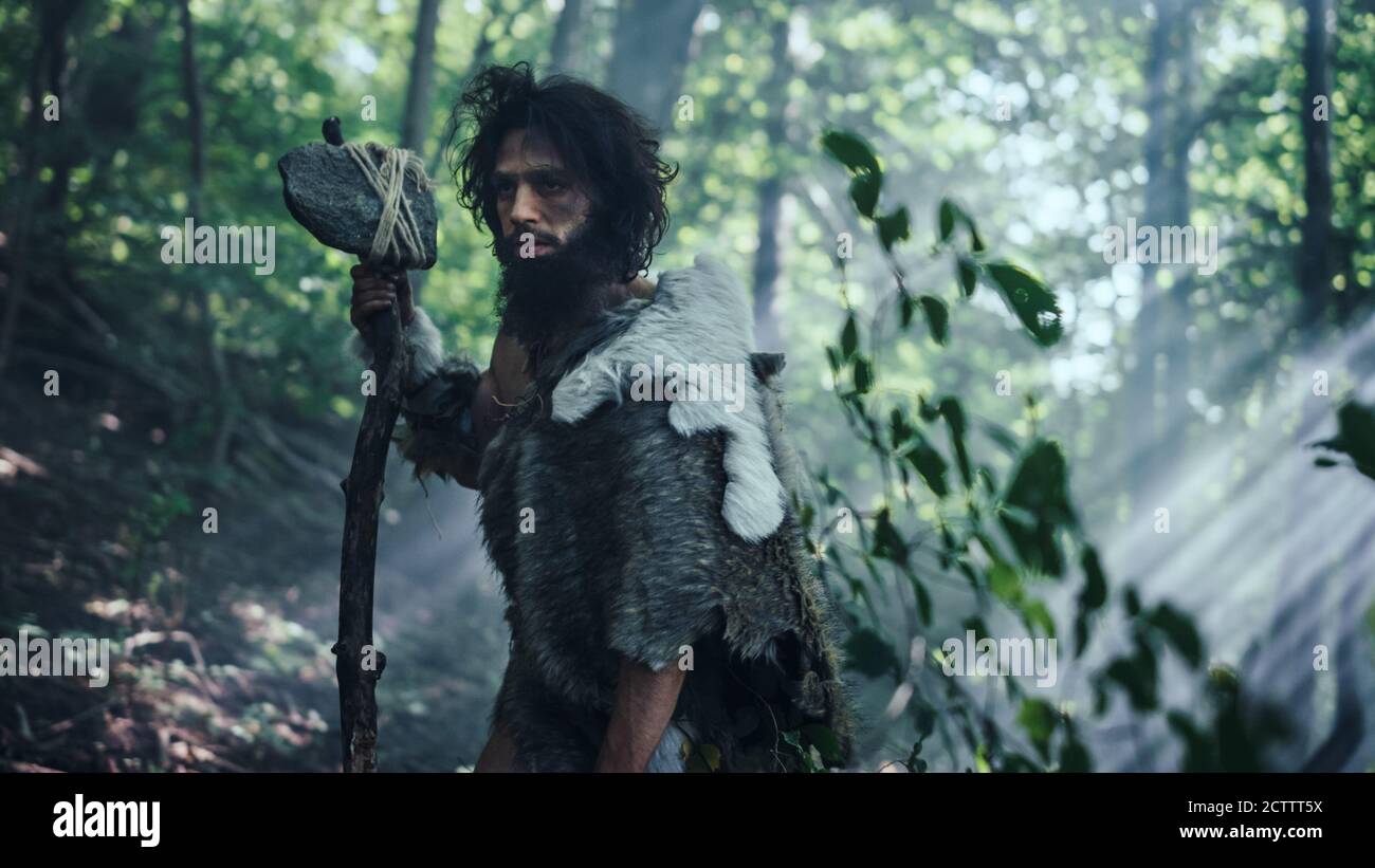 Portrait of Primeval Caveman Wearing Animal Skin and Fur Hunting with a ...