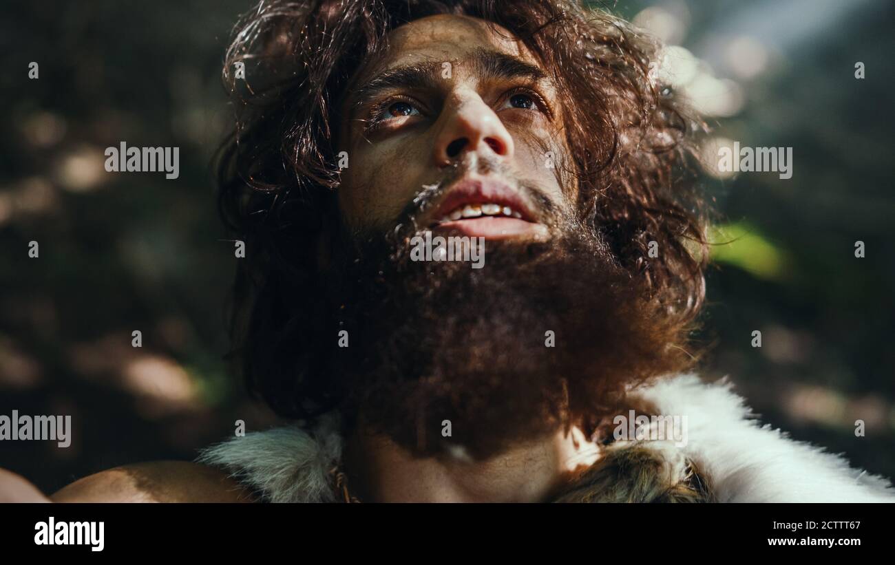 Portrait of Primeval Caveman Wearing Animal Skin Raises Hands to Heaven ...