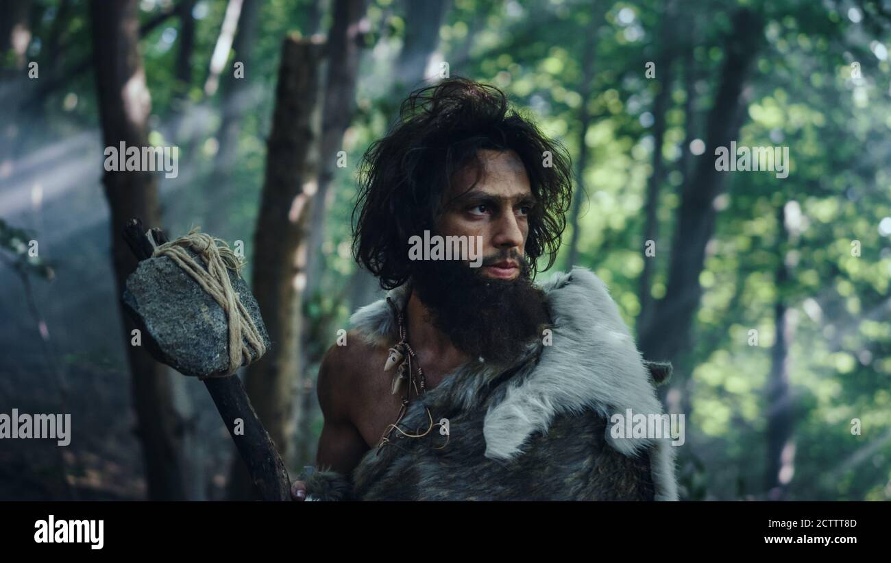 Portrait of Primeval Caveman Wearing Animal Skin and Fur Hunting with a ...