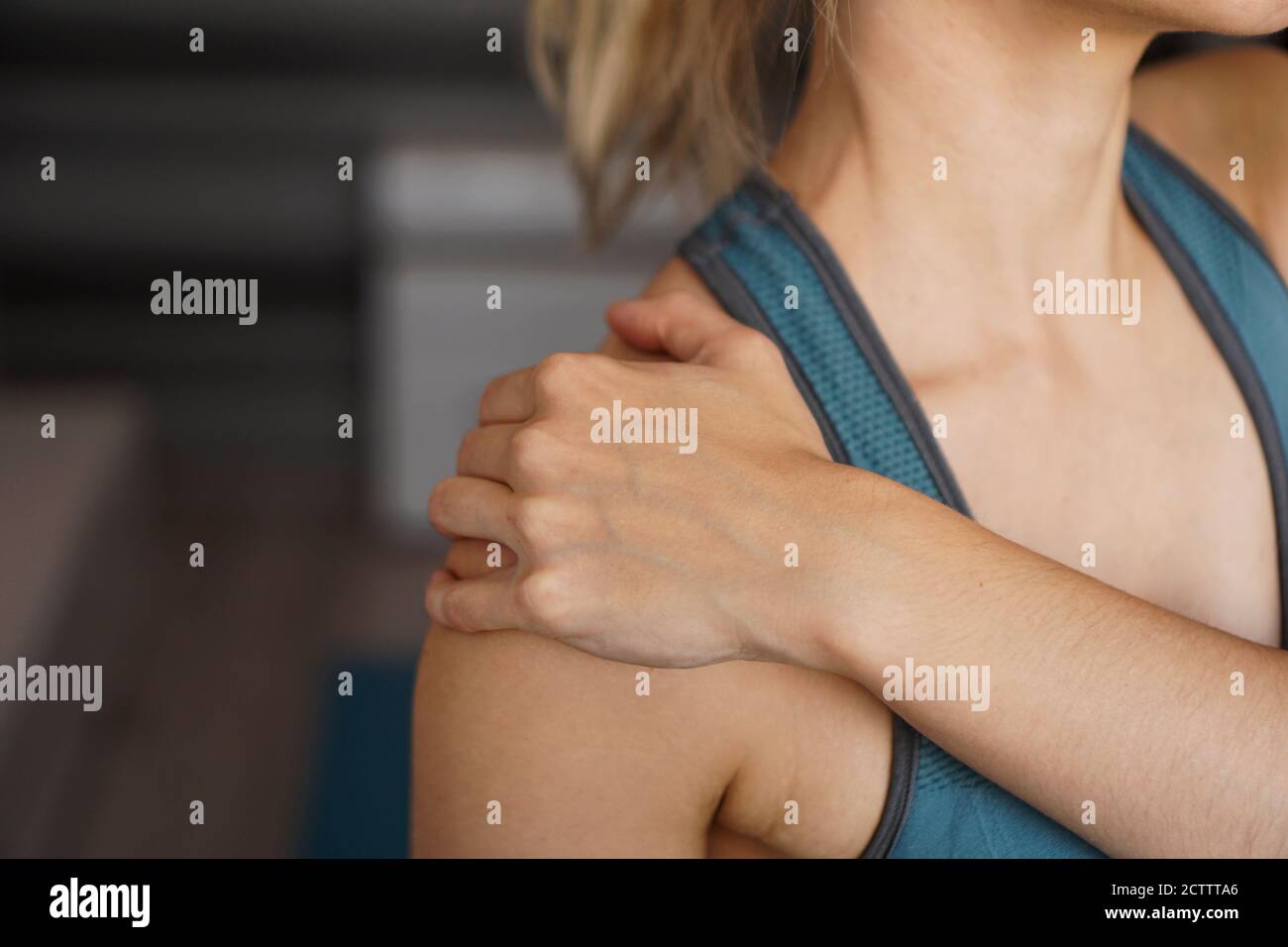 Closeup on fitness woman having pain in shoulder. Pain after home ...