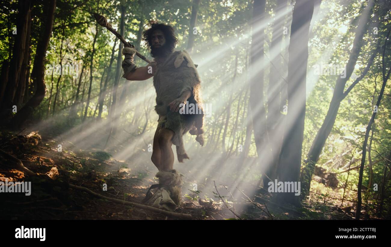 Portrait of Primeval Caveman Wearing Animal Skin and Fur Hunting with a ...