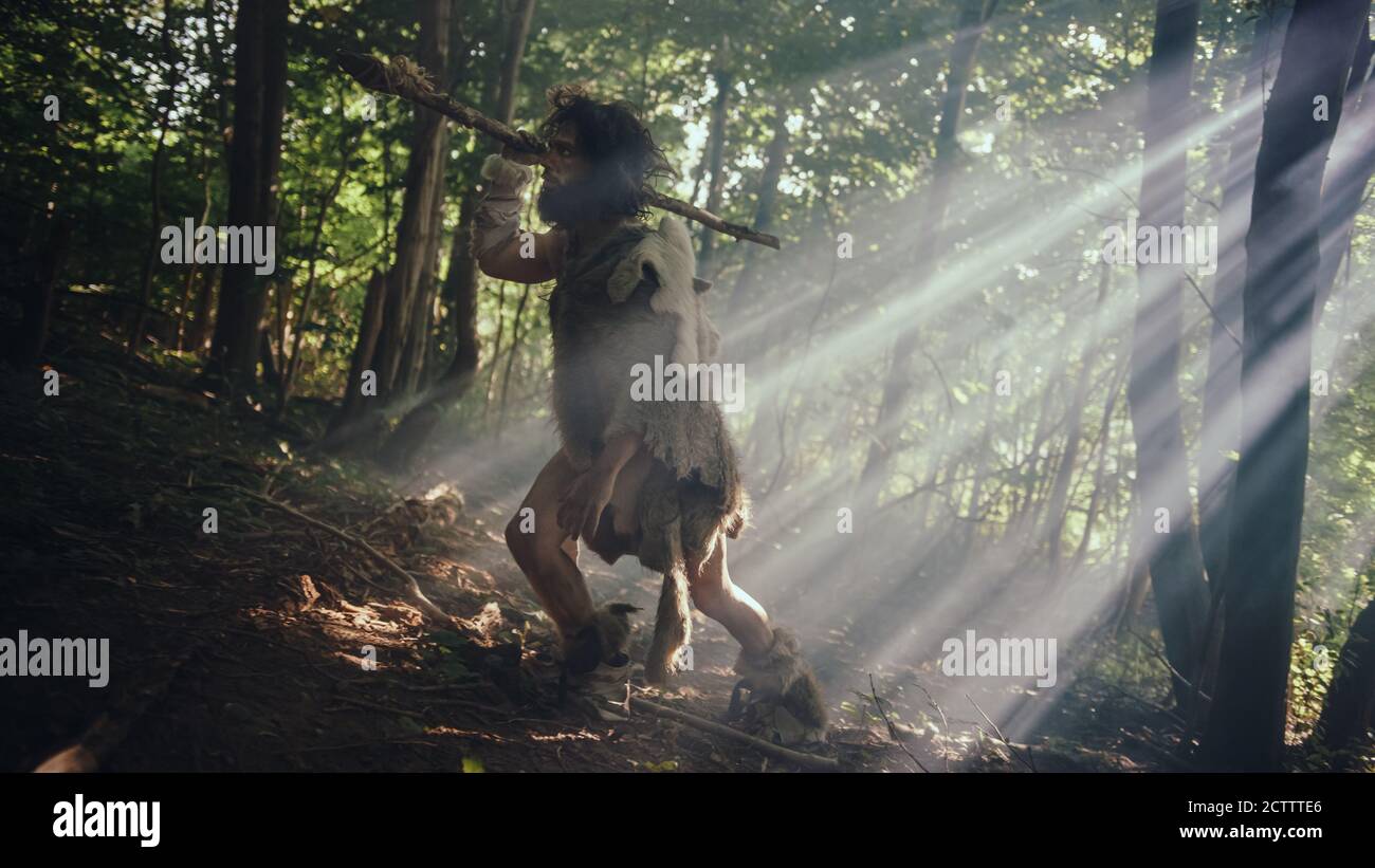 Portrait of Primeval Caveman Wearing Animal Skin and Fur Hunting with a ...