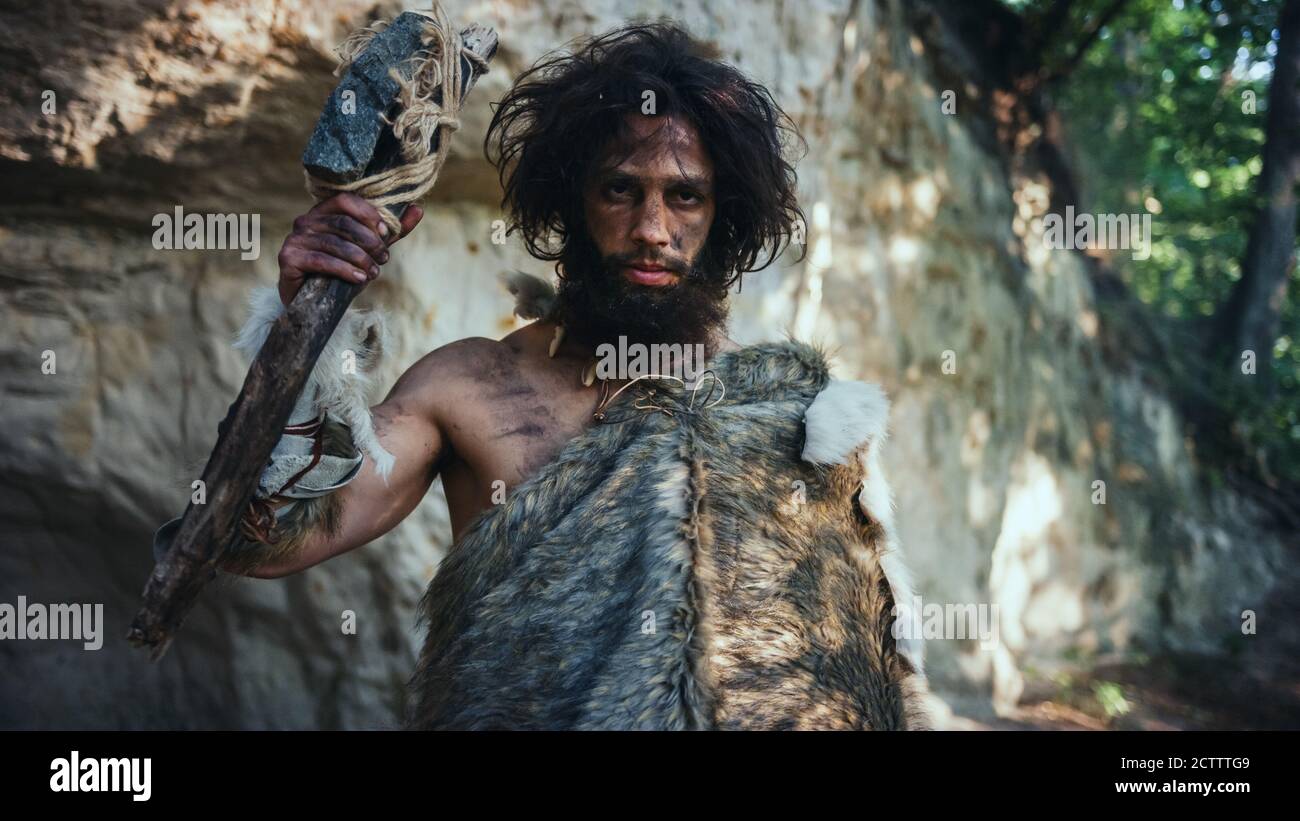 Portrait of Primeval Caveman Wearing Animal Skin Holding Stone Tipped ...