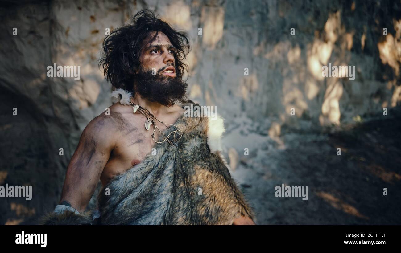 Portrait of Primeval Caveman Wearing Animal Skin Looks Around Forest ...