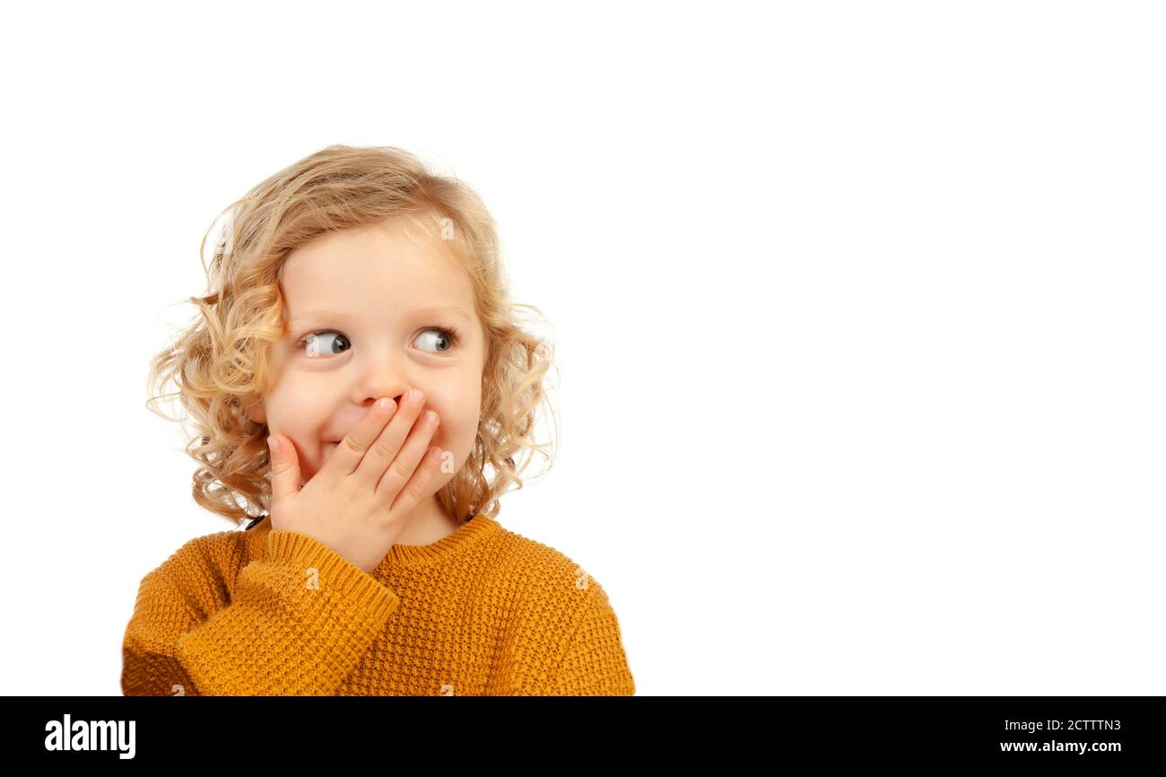 Shy funny child covering his mouth isolated on a white background Stock ...