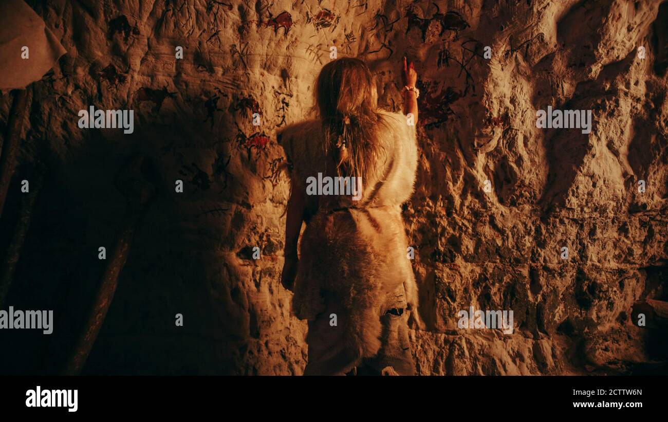 Back View of a Primitive Prehistoric Neanderthal Child Wearing Animal ...