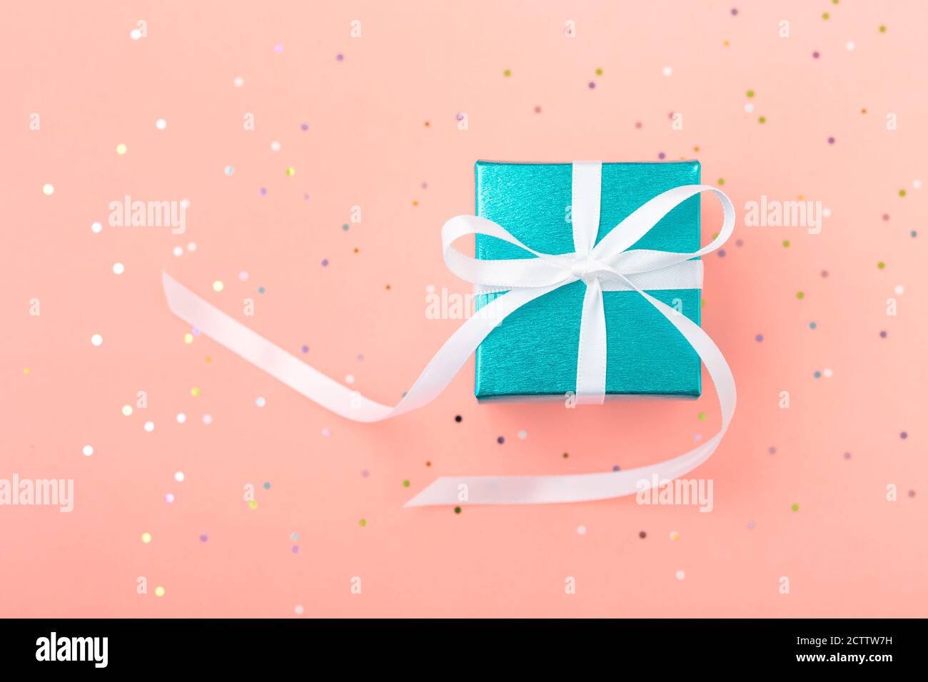Reward gift box with glitter on pastel pink background Stock Photo - Alamy
