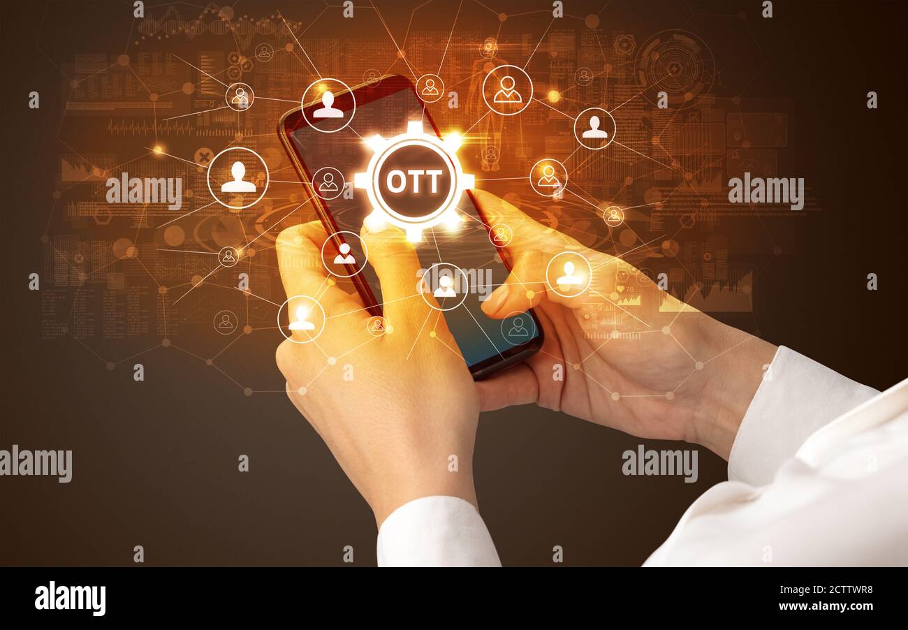 Female hand holding smartphone with OTT abbreviation, modern technology ...