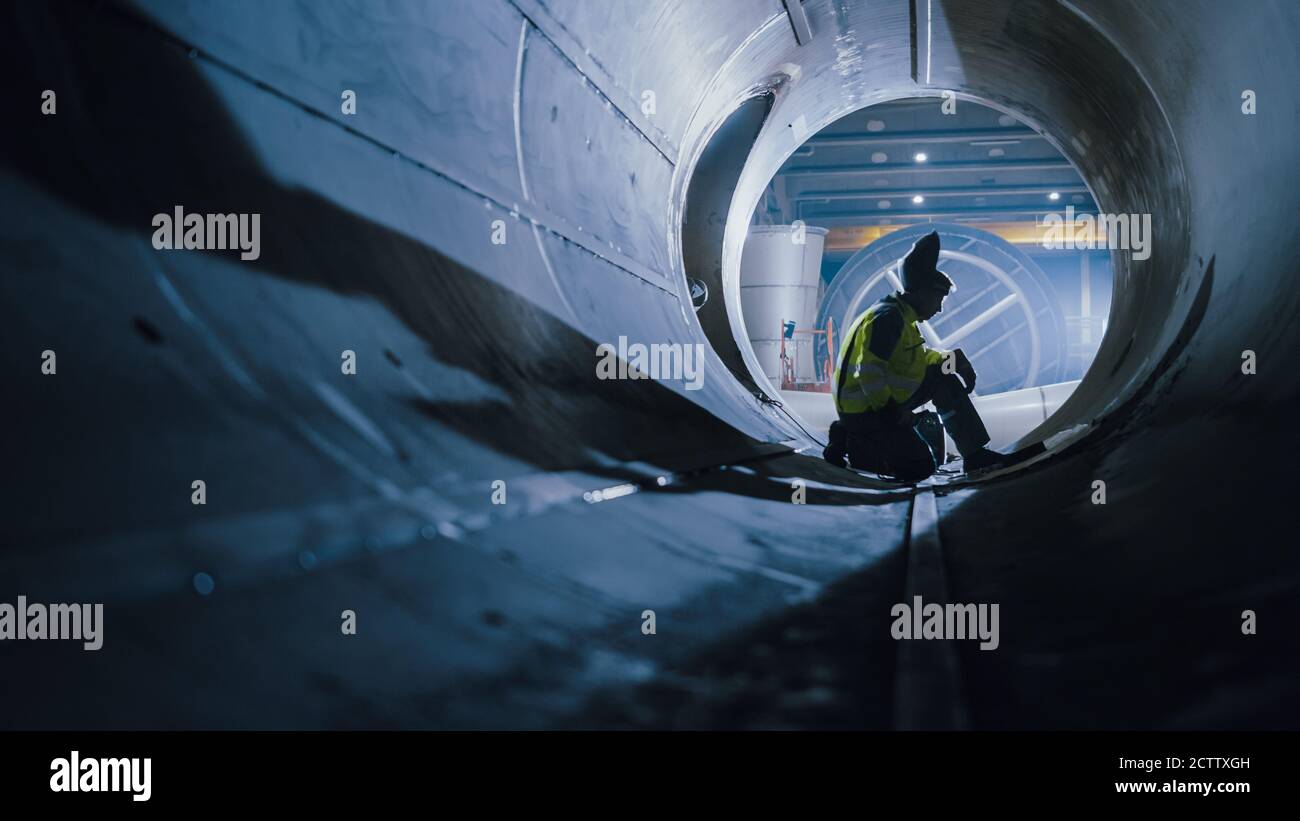 Professional Heavy Industry Welder Working Inside Pipe, Wears Helmet ...