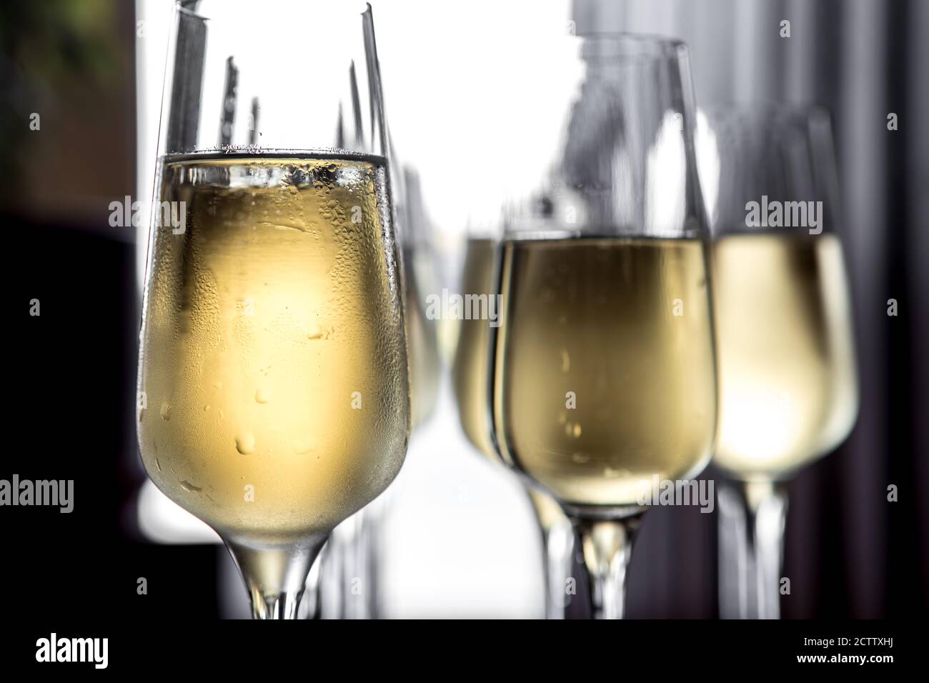 Cool champagne is poured into glass glasses. Condensation on the glass ...
