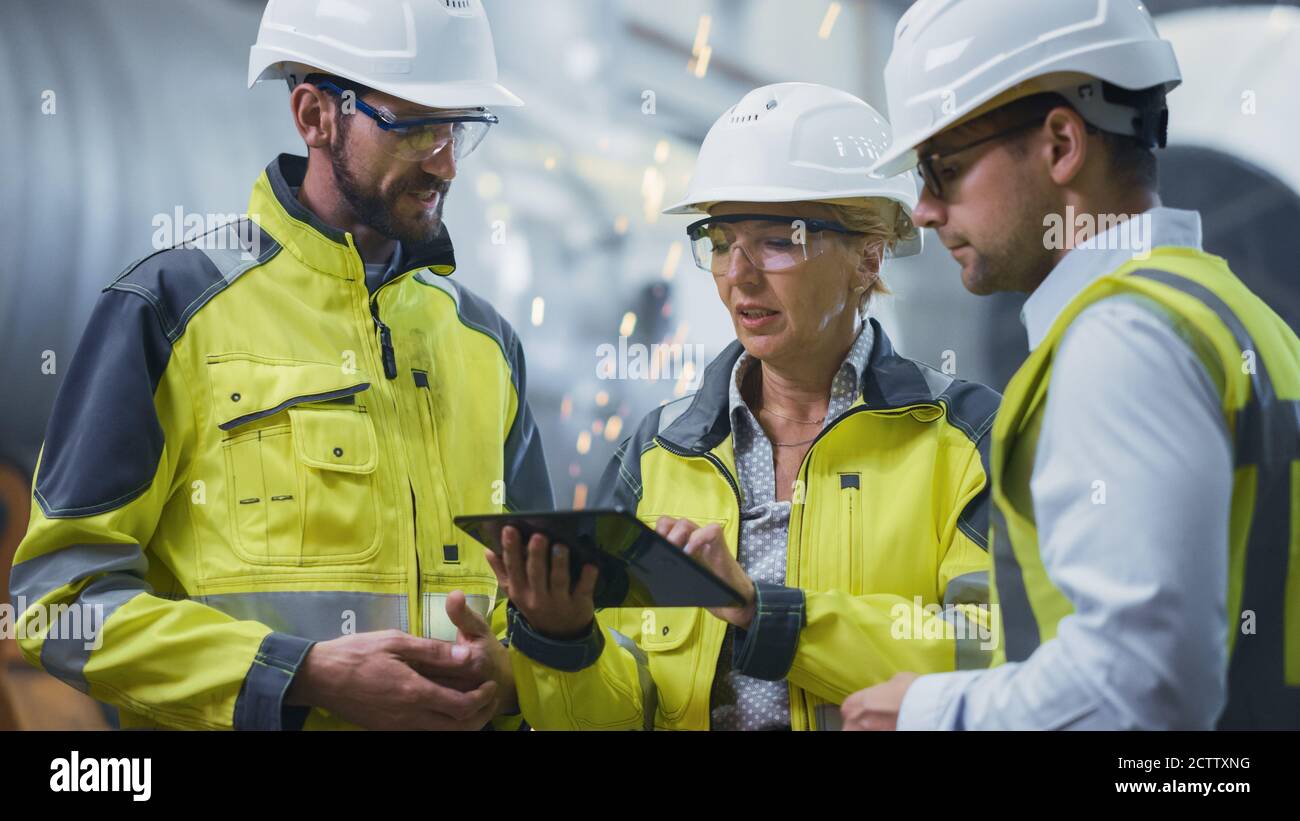 Three heavy industry engineers stand hi-res stock photography and ...