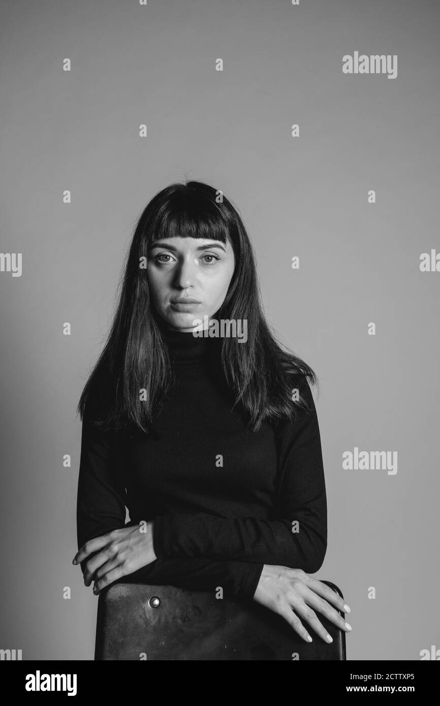 Girl standing behind chair Black and White Stock Photos & Images - Alamy