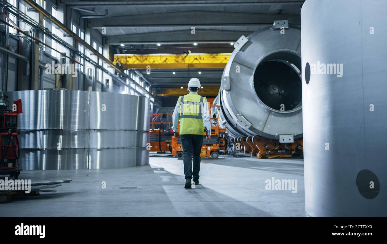 Following Shot of Heavy Industry Engineers Walking Through ...