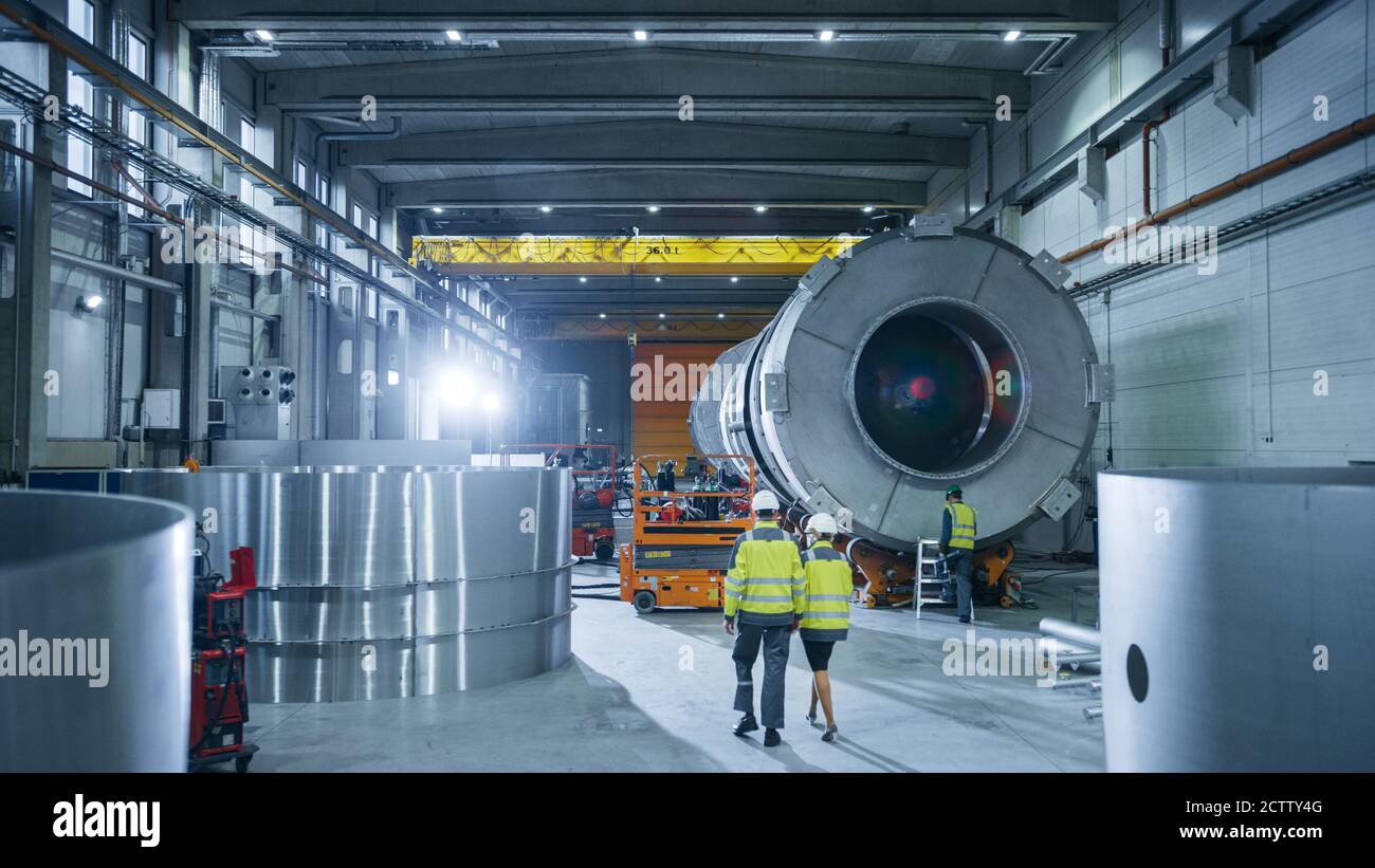 Team of Engineers and Professionals Working on a Pipe Manufacturing ...