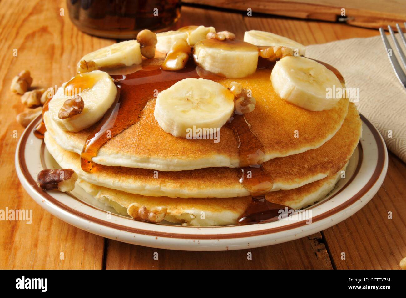Banana nut pancakes with maple syrup Stock Photo - Alamy
