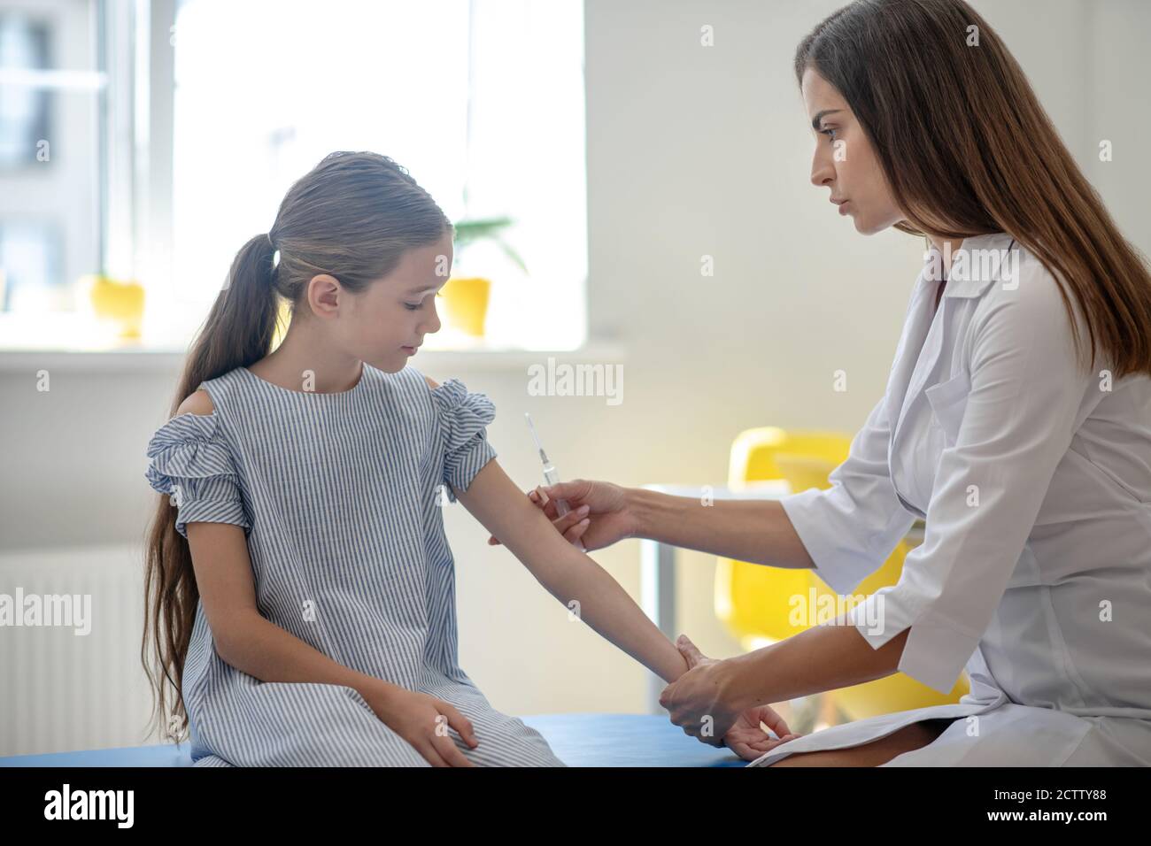 Doctor applying a plaster to a place of injection Stock Photo - Alamy