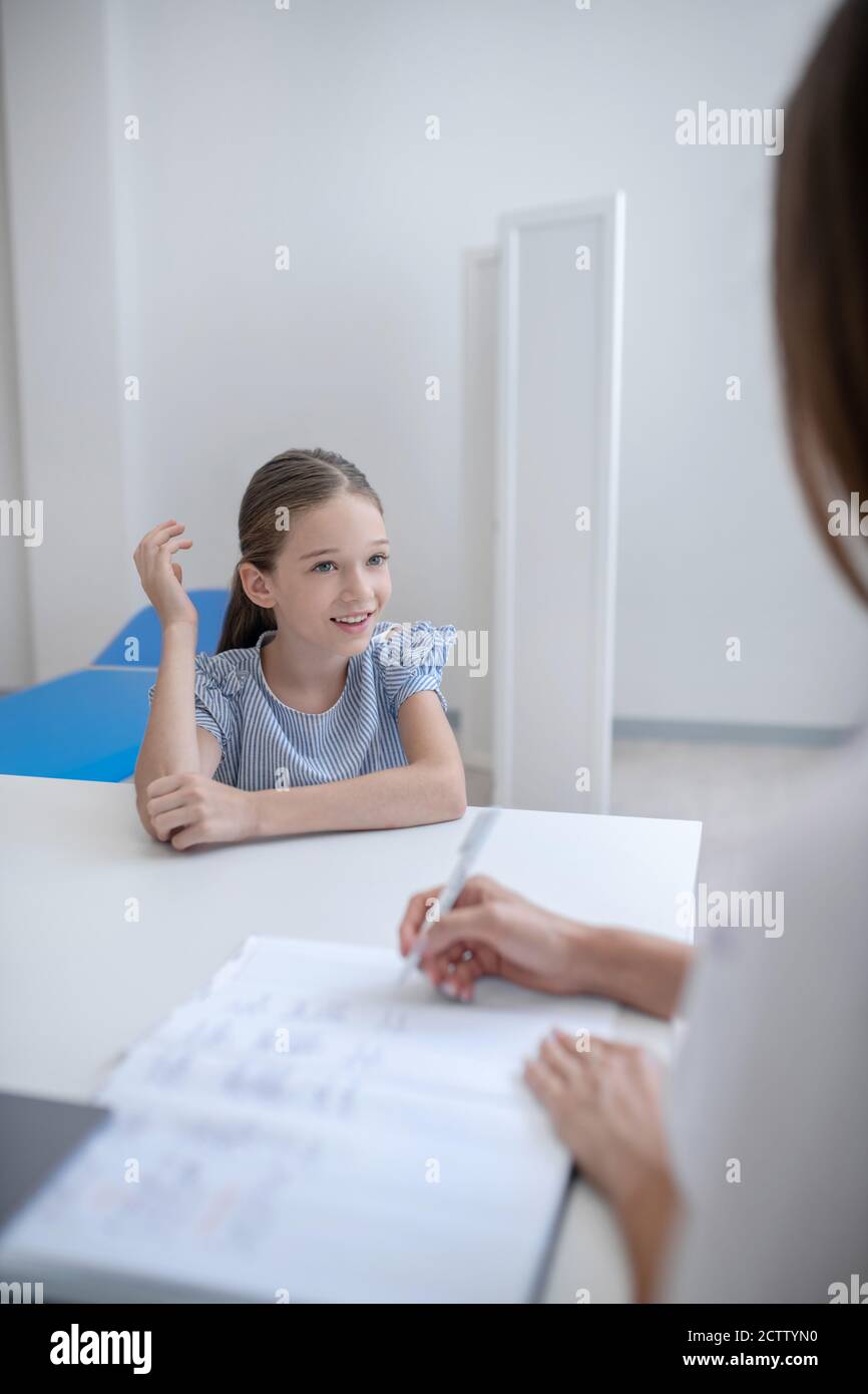 Girl having a tutorial in the clinic with a female doctor and looking ...