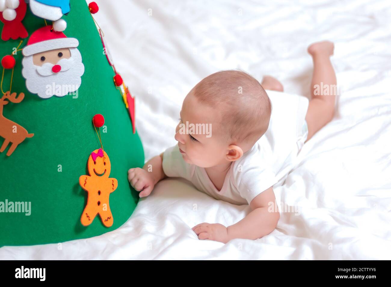 Baby under a christmas tree hi-res stock photography and images - Alamy
