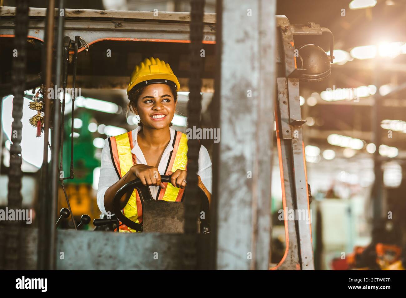 American black women labor worker at forklift driver happy working in industry factory logistic ...