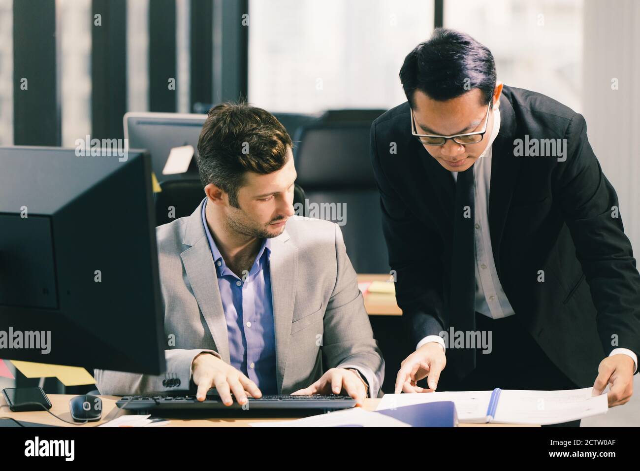 Two business man talking with partner mix race Asian and Caucasian male ...