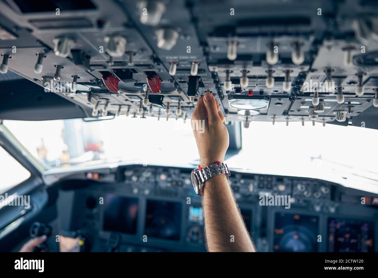 Pilot hand pushing on the dashboard in the aircraft Stock Photo - Alamy