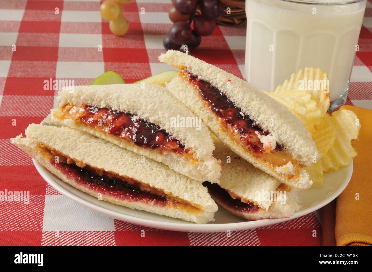 Peanut butter and jelly sandwich with the crust trimmed off Stock Photo ...