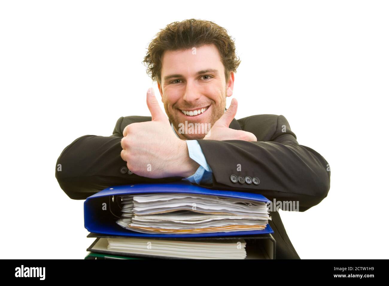 Young man in suit with a pile of files shows with both thumbs up Stock ...