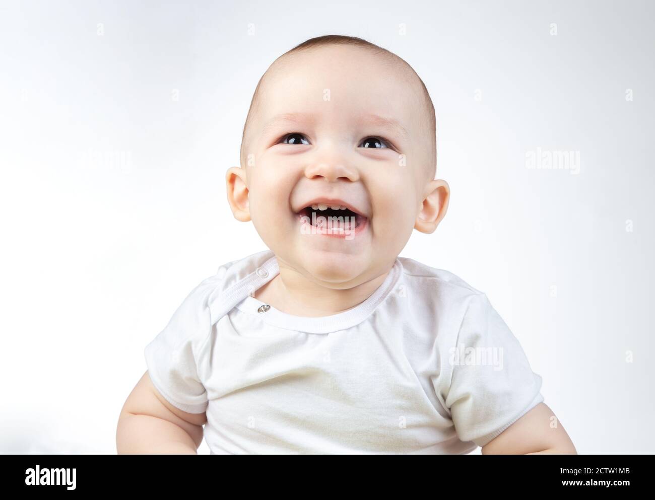 Photo of looking up eleven-month-old baby on a white background Stock ...