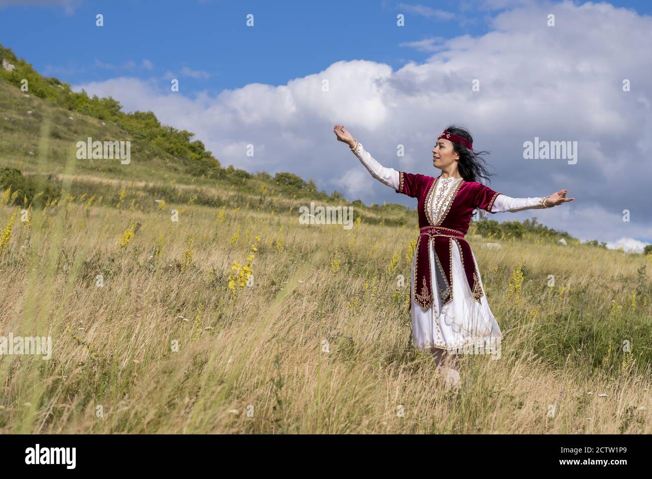 Young girl dancing national dance in an open field Stock Photo - Alamy