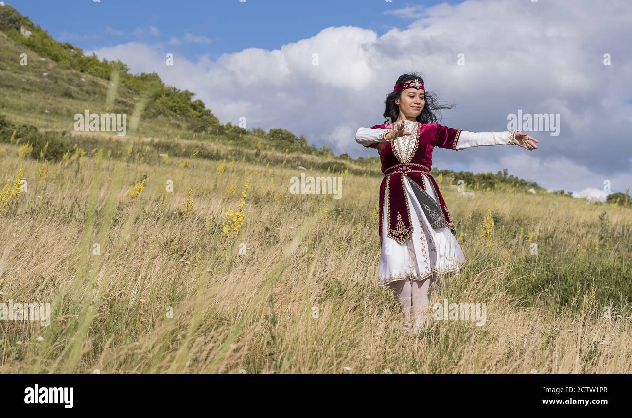 Young girl dancing national dance in an open field Stock Photo - Alamy