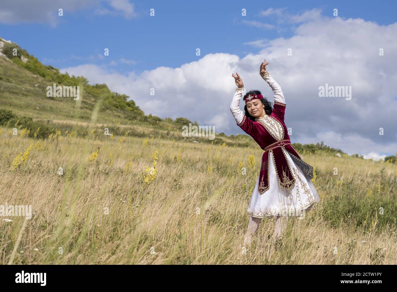 Young girl dancing national dance in an open field Stock Photo - Alamy