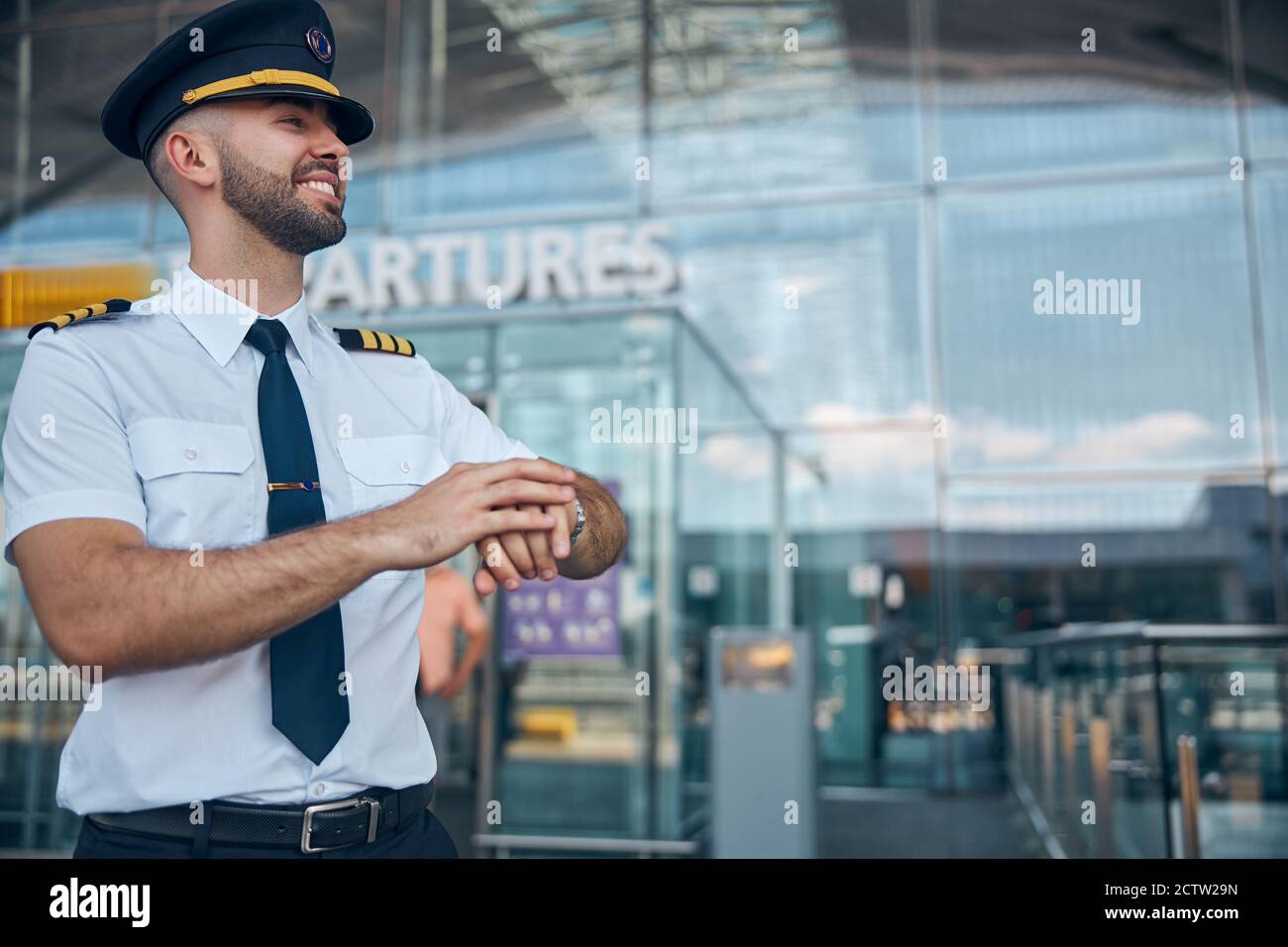 Cheerful male pilot standing on the street Stock Photo - Alamy