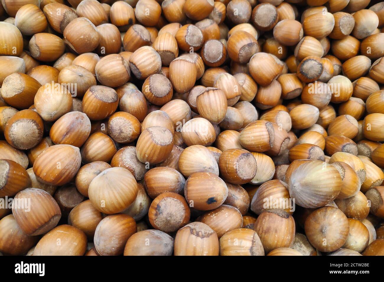 Close-up on a stack of hazelnuts on a market stall Stock Photo - Alamy