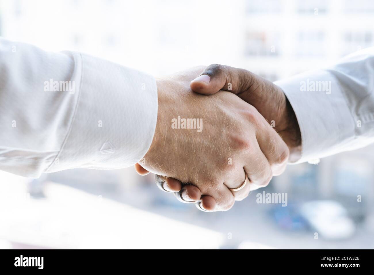 Close-up handshaking of two colleagues African business man and ...