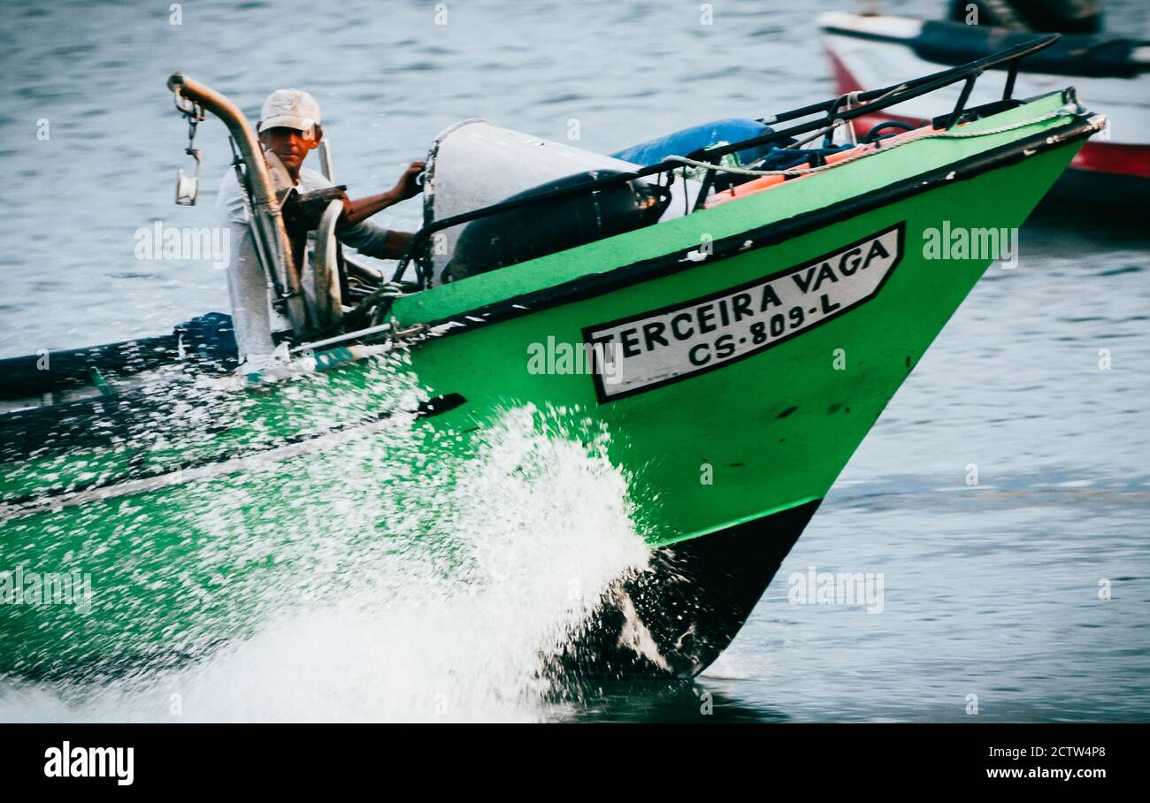 Fisherman on a fast moving boat Stock Photo - Alamy