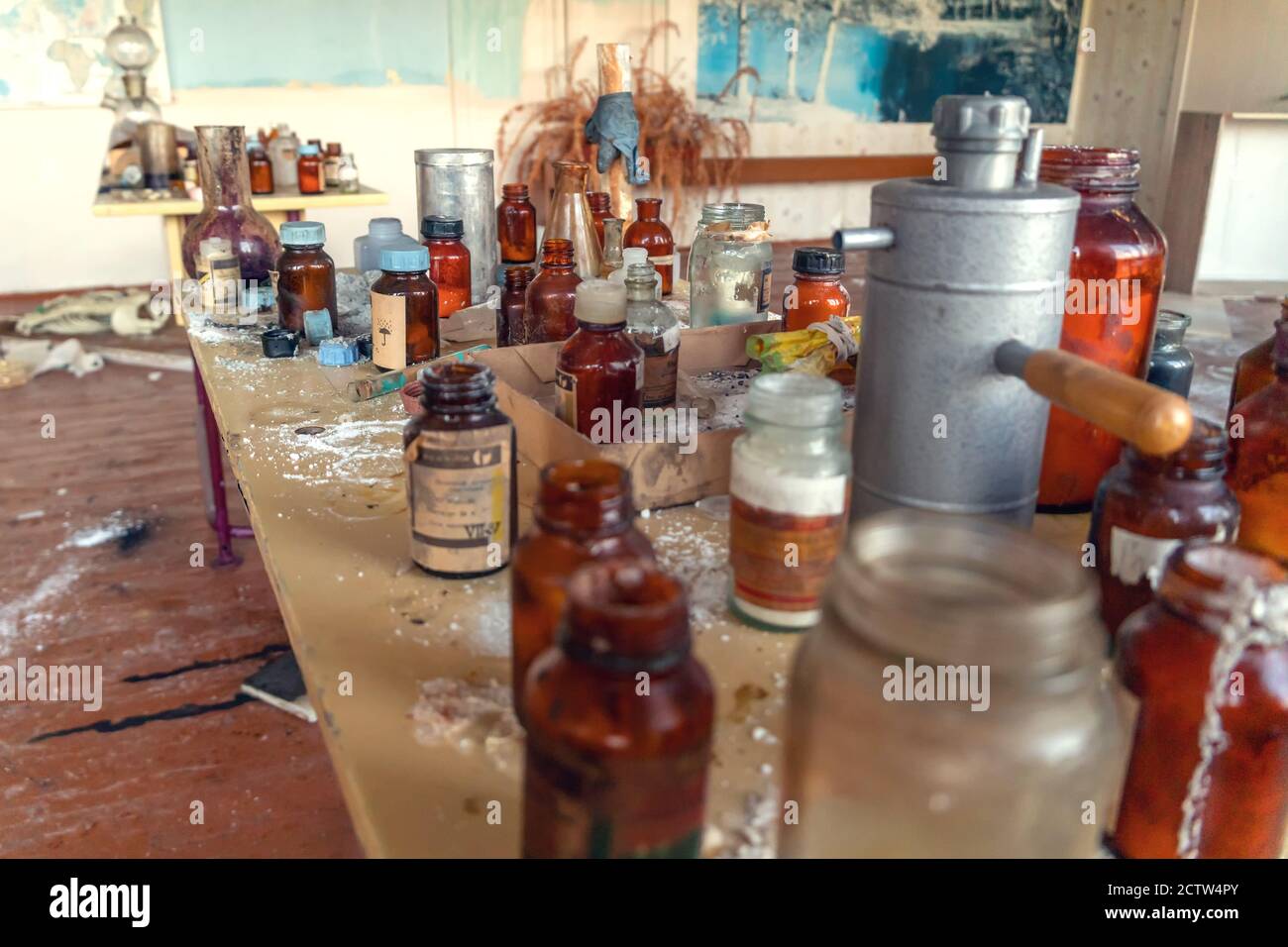 table with old chemical reagents in a classroom in an abandoned school ...