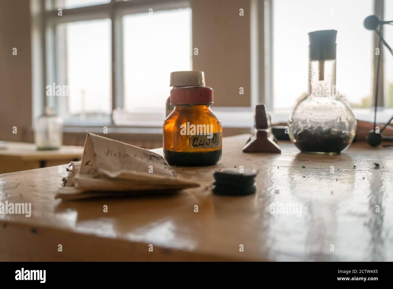 table with old chemical reagents in a classroom in an abandoned school ...