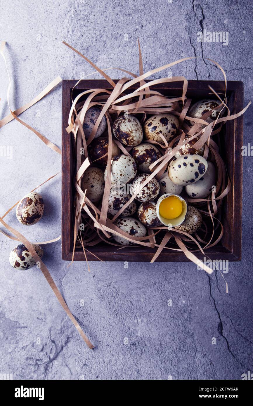Quail eggs. Flat lay composition with small quail eggs in the wooden ...