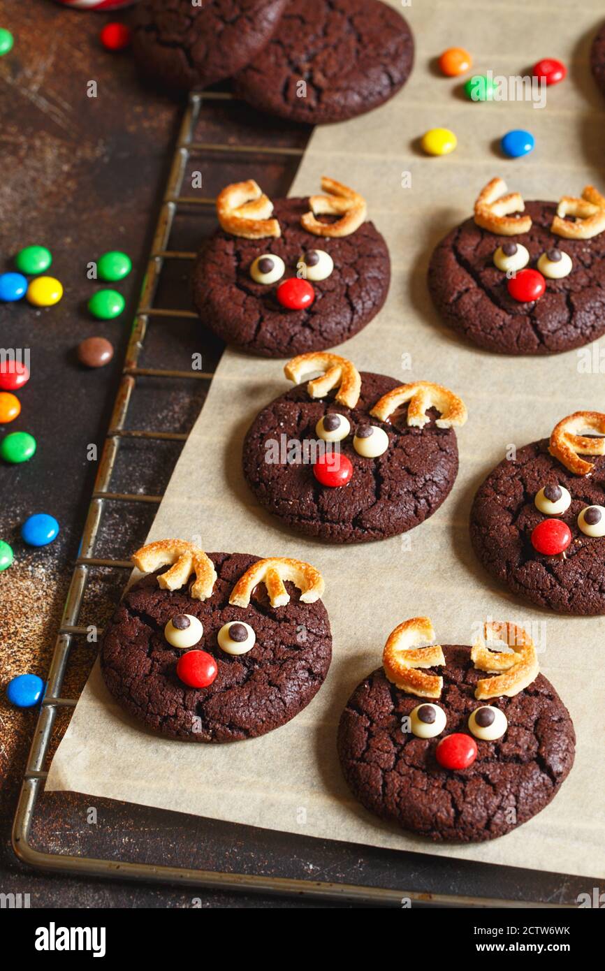 Reindeer cookies with candy red nose on a baking paper. Christmas ...