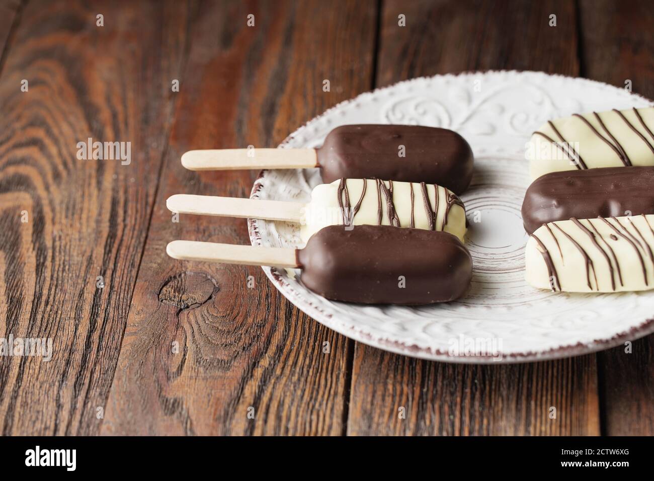 Milk chocolate popsicles on a stick. Ice cream popsicles covered with ...