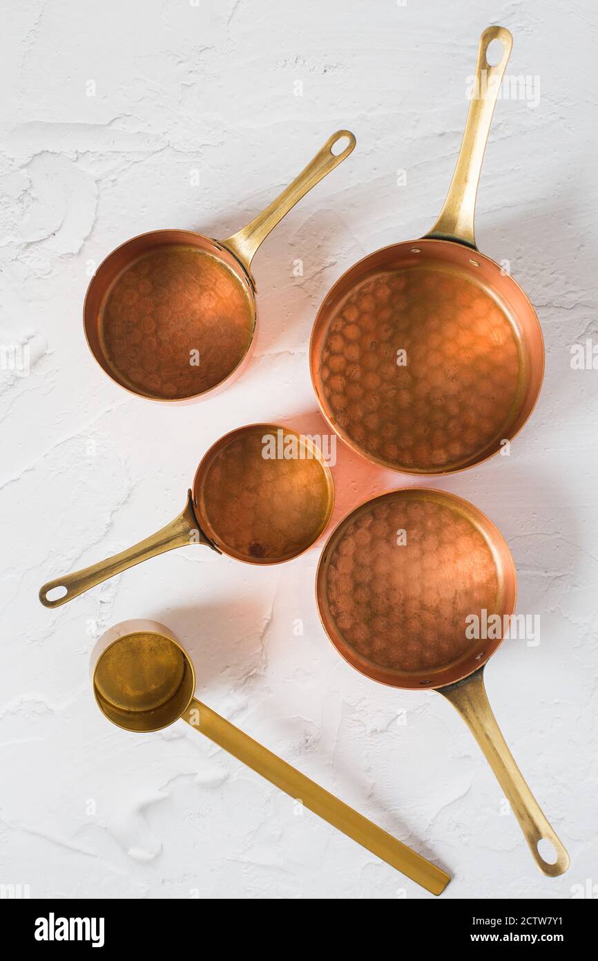 Copper utensils on the white background. Vintage copper cookware ...