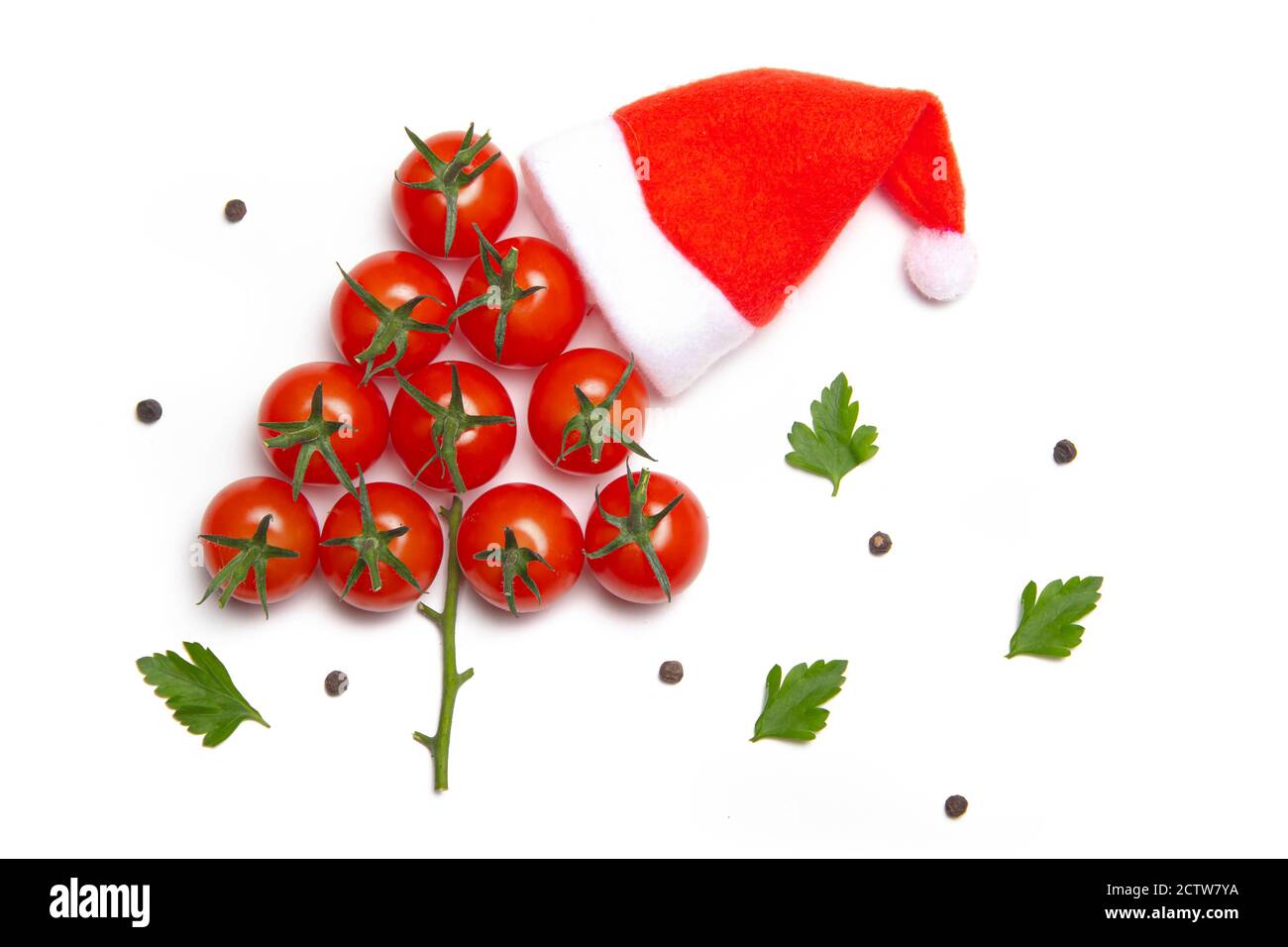 Cherry tomato Christmas tree and Santa hat on white background ...