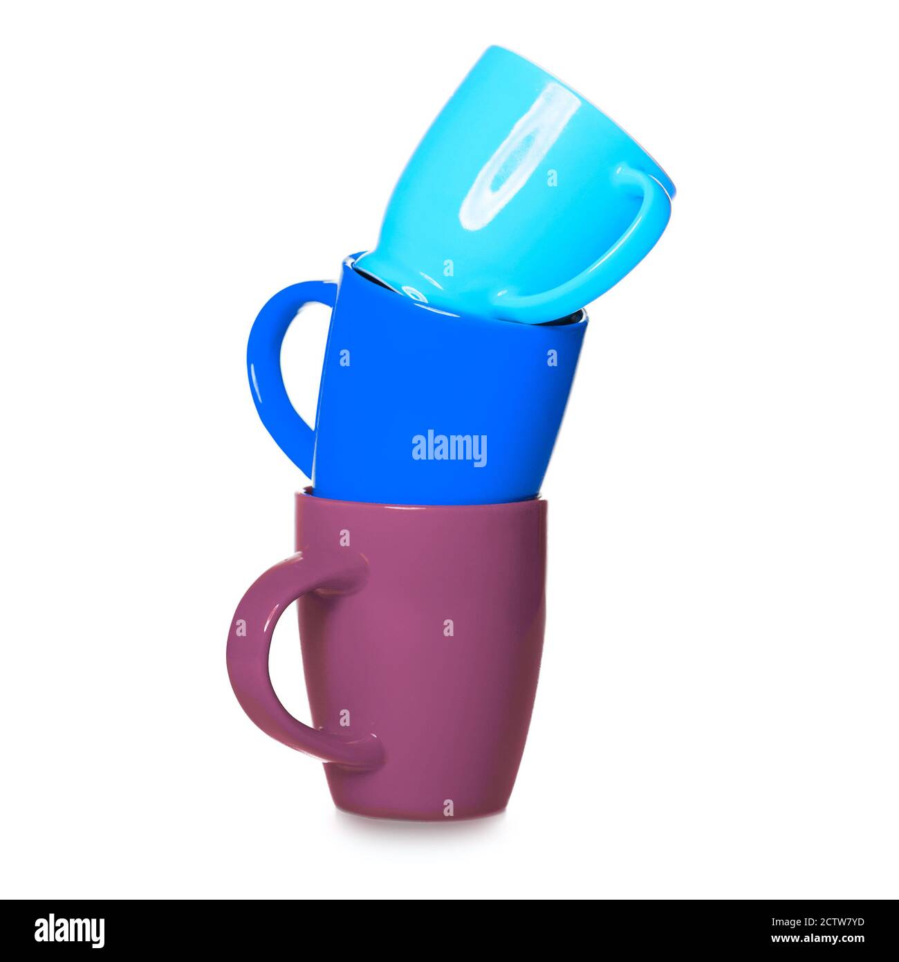Stack of three motley cups isolated on white background. Three coffee ...