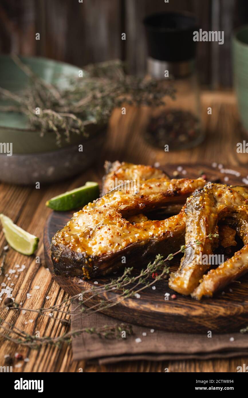 Carp baked in honey mustard sauce, decorated with thyme. Fried Slices ...