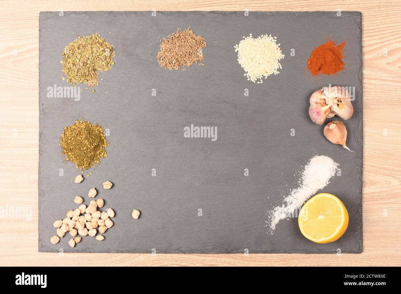 Various herbs and spices for hummus on stone tray. High resolution ...